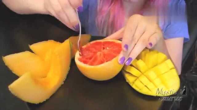 Grapefruit, mango, honeydew melon, beautiful woman eats deliciously ...