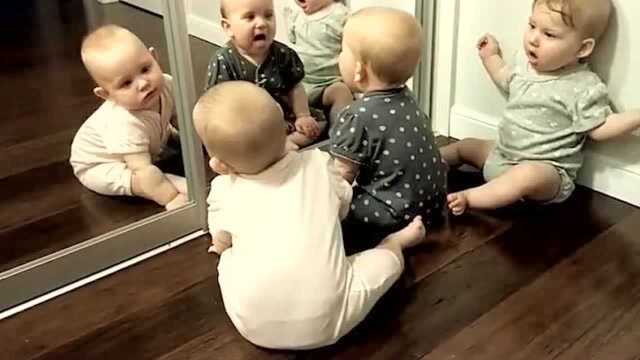 The triplets cute baby is playing in the mirror, and instantly makes ...