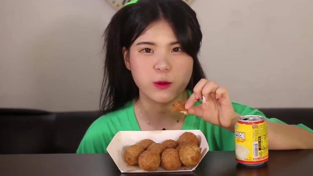 Pretty girl eating fried cheese balls, very chewy, looking good to eat ...