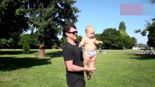 Little fat man standing on the father's arm, playing balance, this body ...