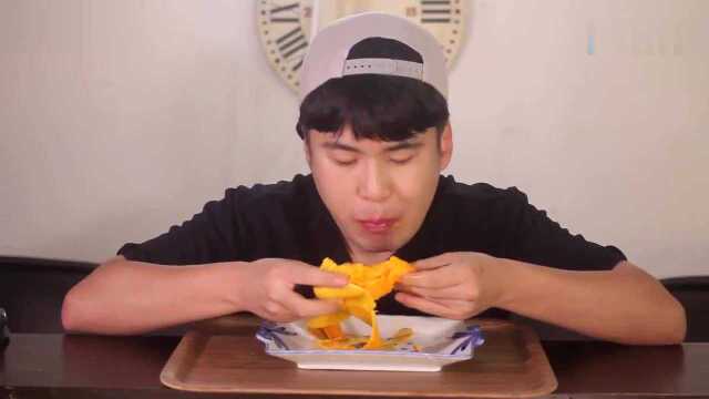 Korean handsome guy eats fresh and juicy mango, listens to the sound ...